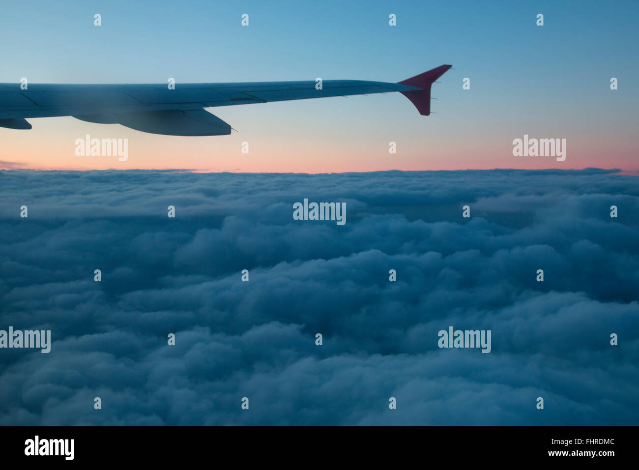 White and red wing of a Turkish Airlines airplane flying above the dark ...