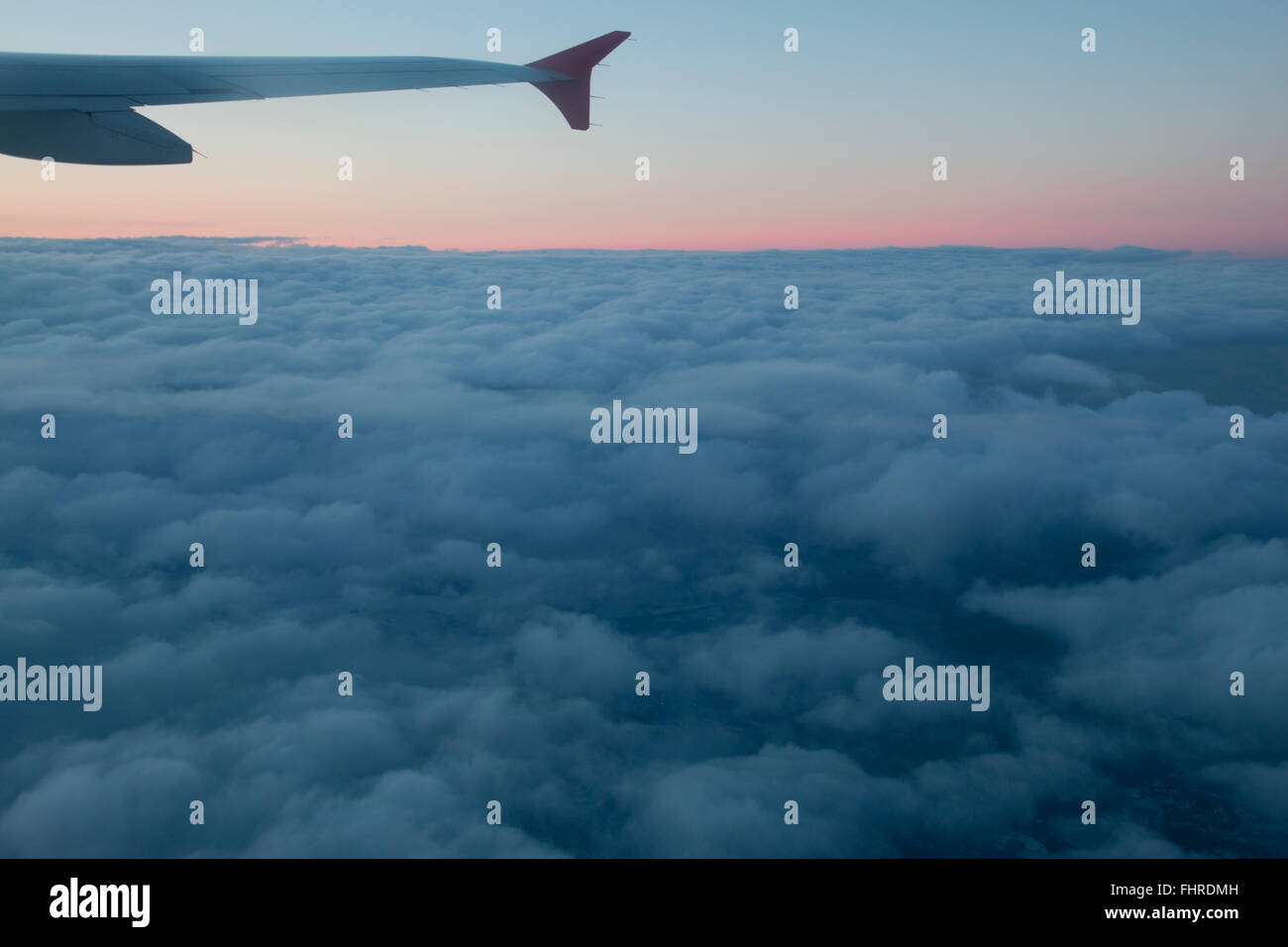 White and red wing of a Turkish Airlines airplane flying above the dark ...