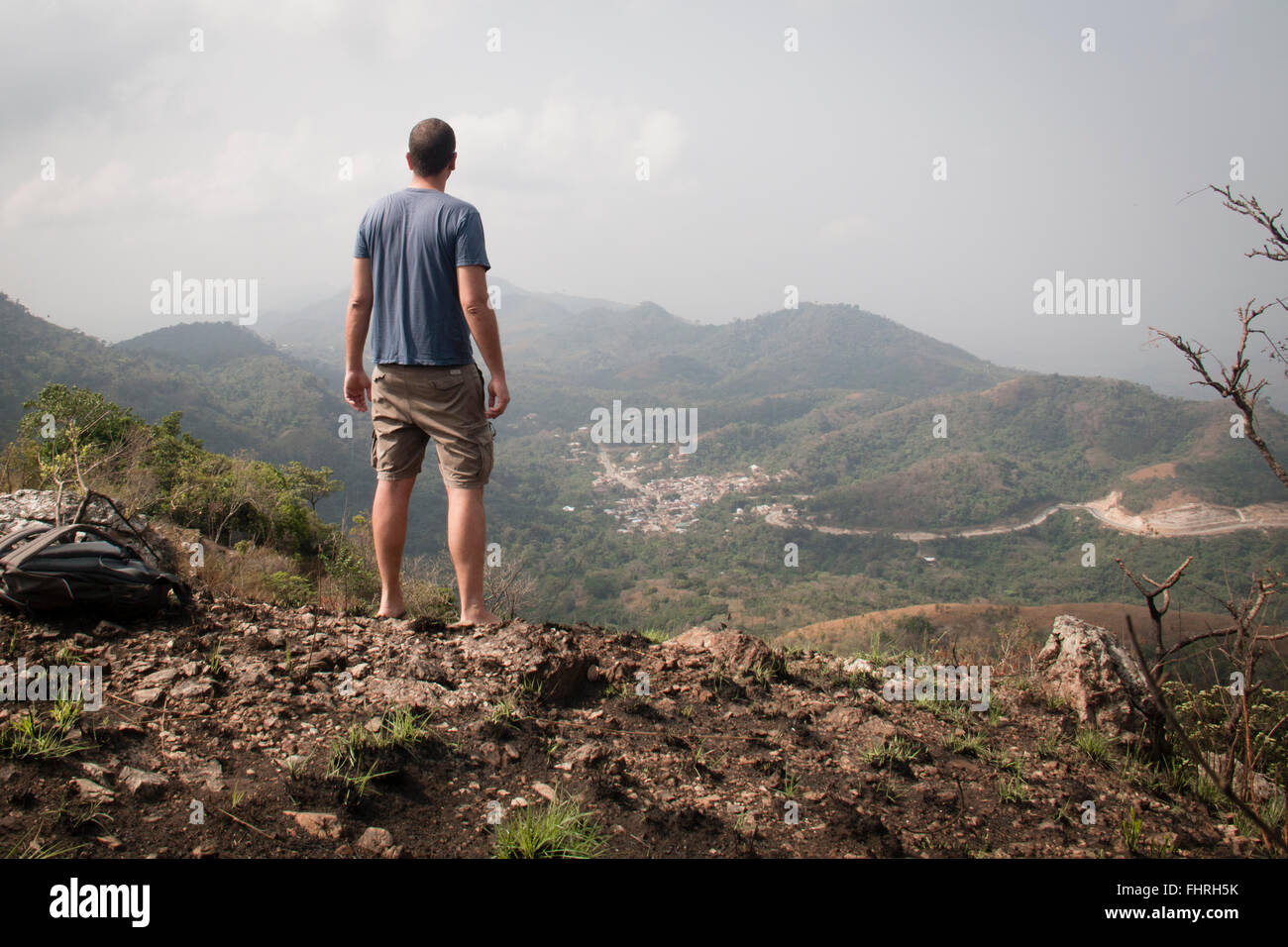 Beautiful landscape with a man overlooking the valley in the mountains ...