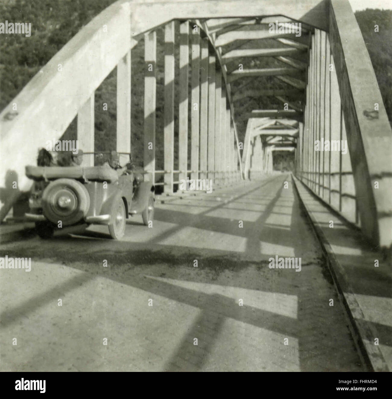 Two soldiers cross a bridge by car Stock Photo - Alamy