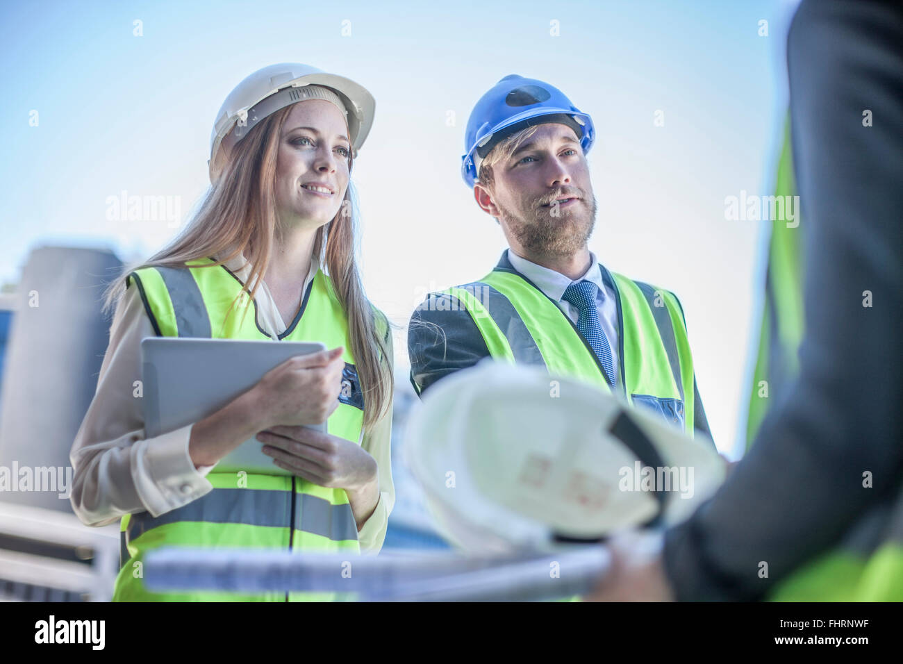 Architect and engineer at construction site discussing project Stock ...