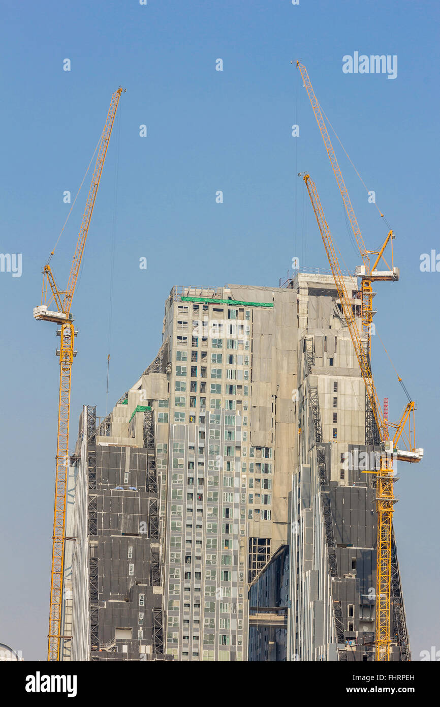 Inside place for many tall buildings under construction and cranes ...