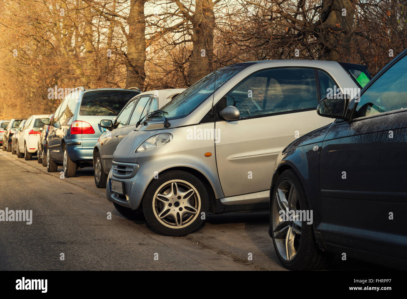 Small car parking sideways to the other cars Stock Photo - Alamy