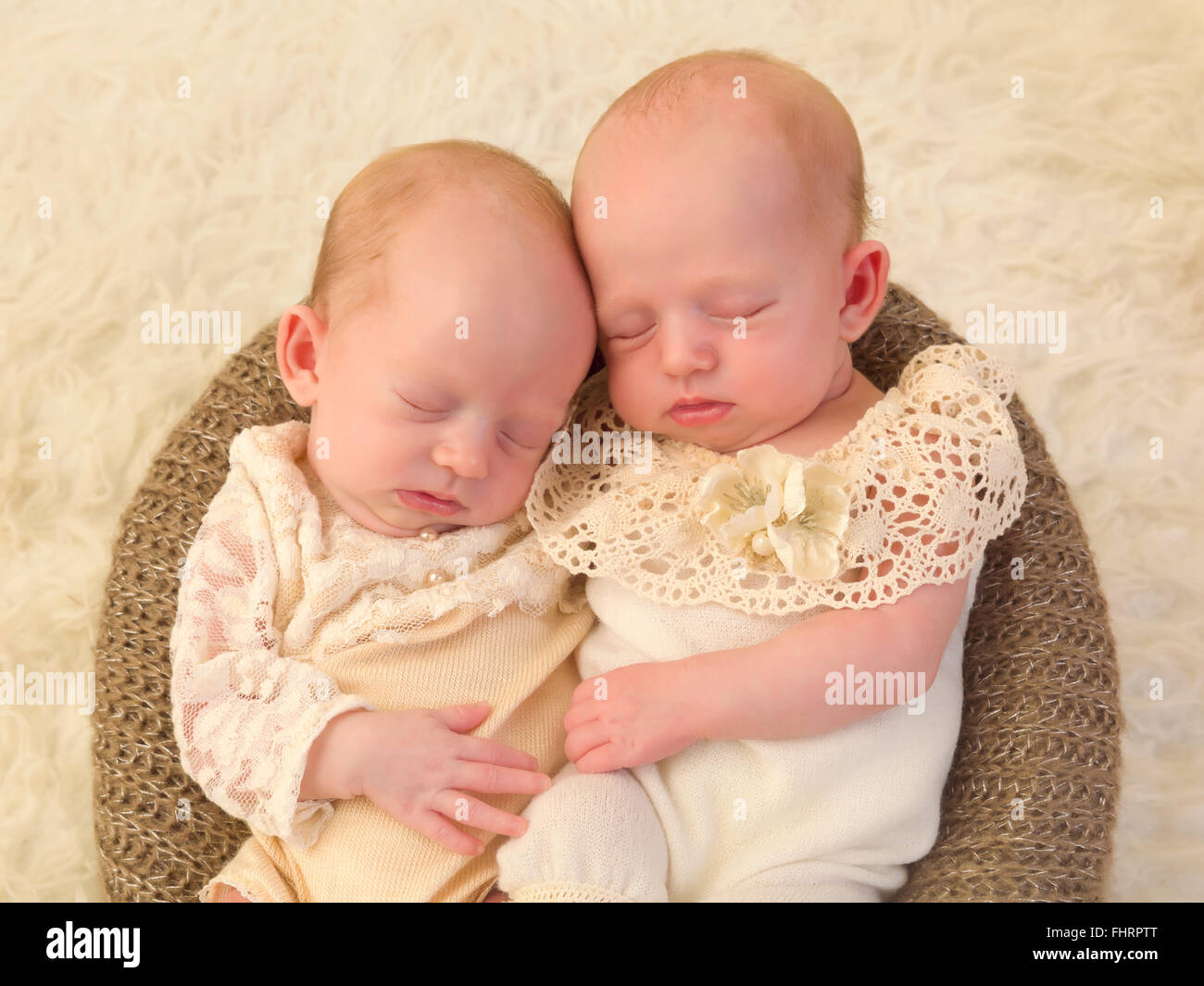 Three weeks old newborn identical twin babies dressed in lace Stock ...