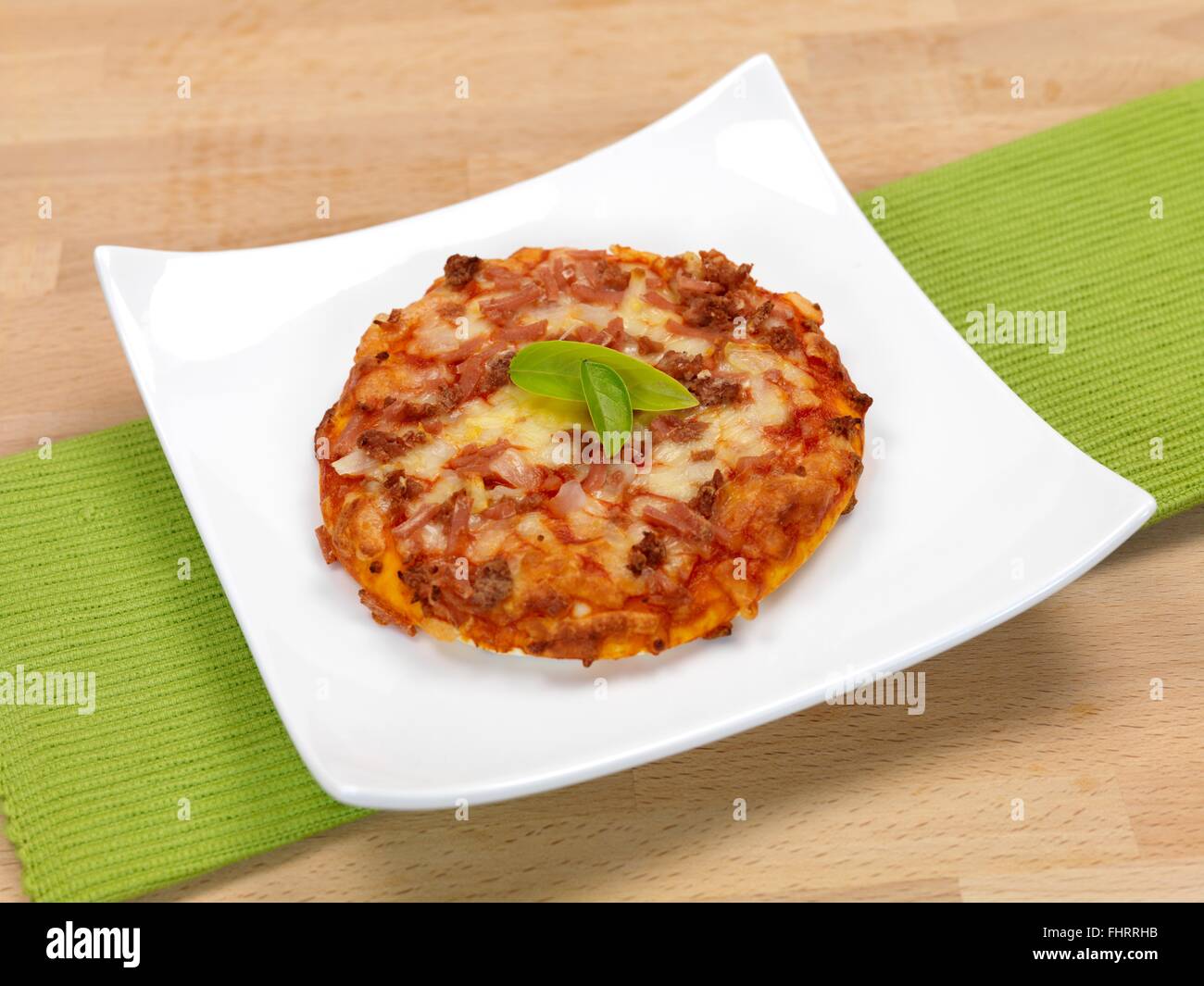 Mini Pizzas isolated on a kitchen bench Stock Photo - Alamy