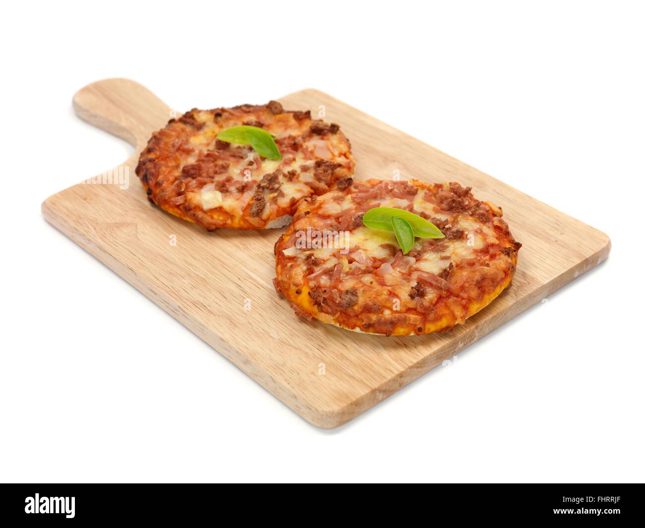 Mini Pizzas isolated on a kitchen bench Stock Photo - Alamy