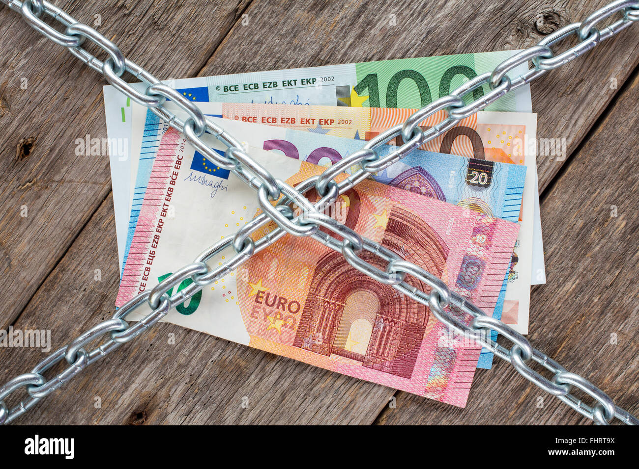 European currency with chain , concept money tied up Stock Photo - Alamy