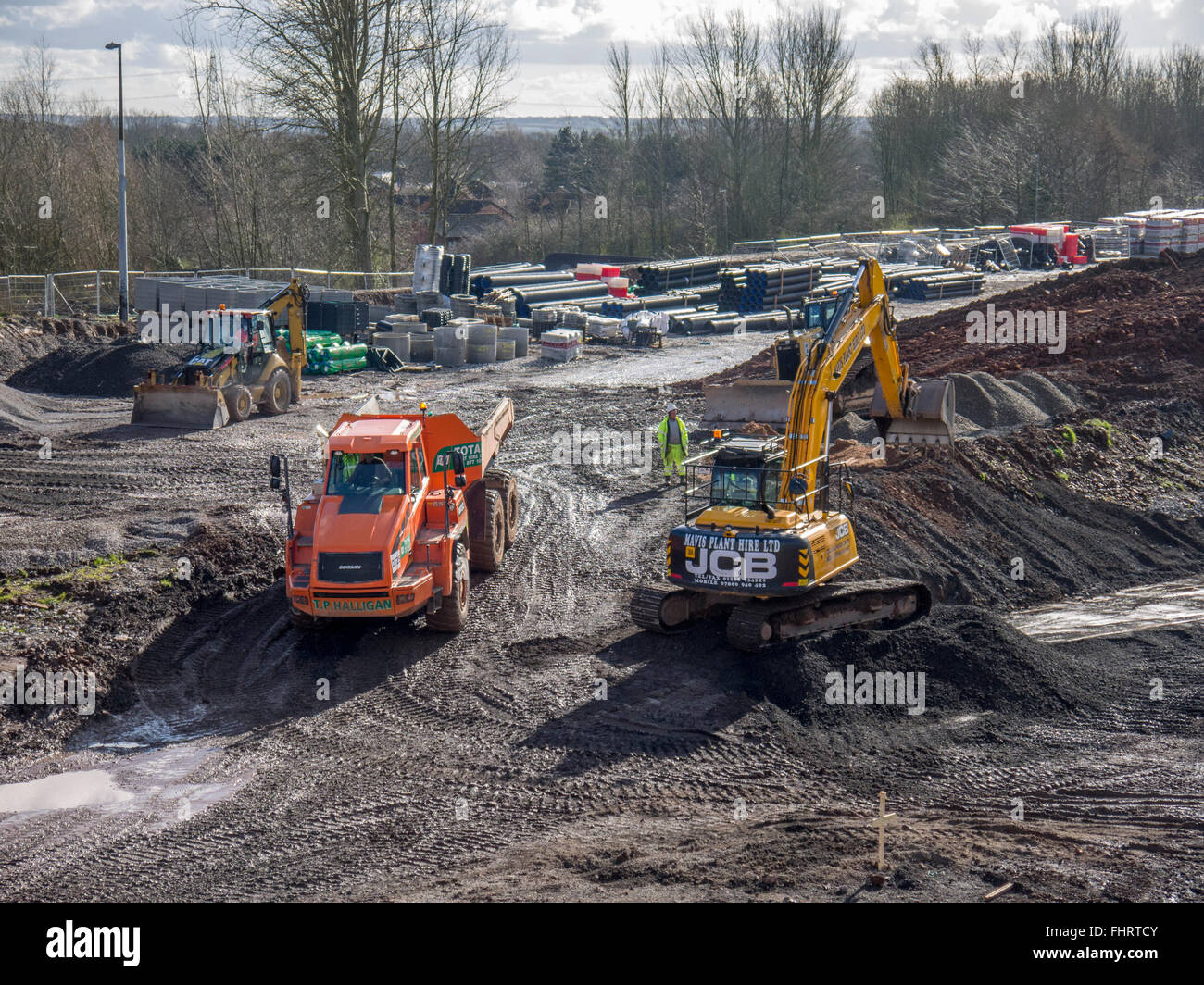 Construction site showing a digger, JCB and construction workers Stock ...