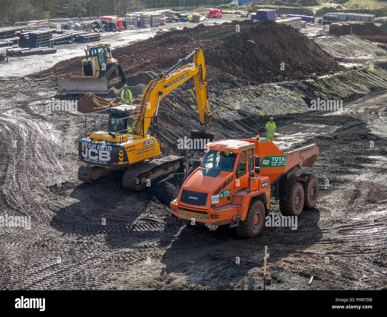 Dump truck being loaded by a digger on a construction site Stock Photo ...