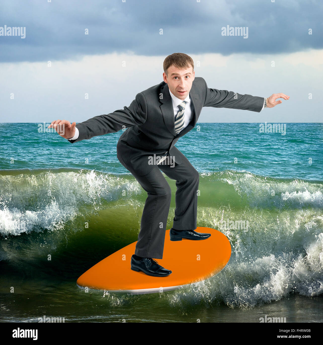 Businessman on surfboard Stock Photo - Alamy