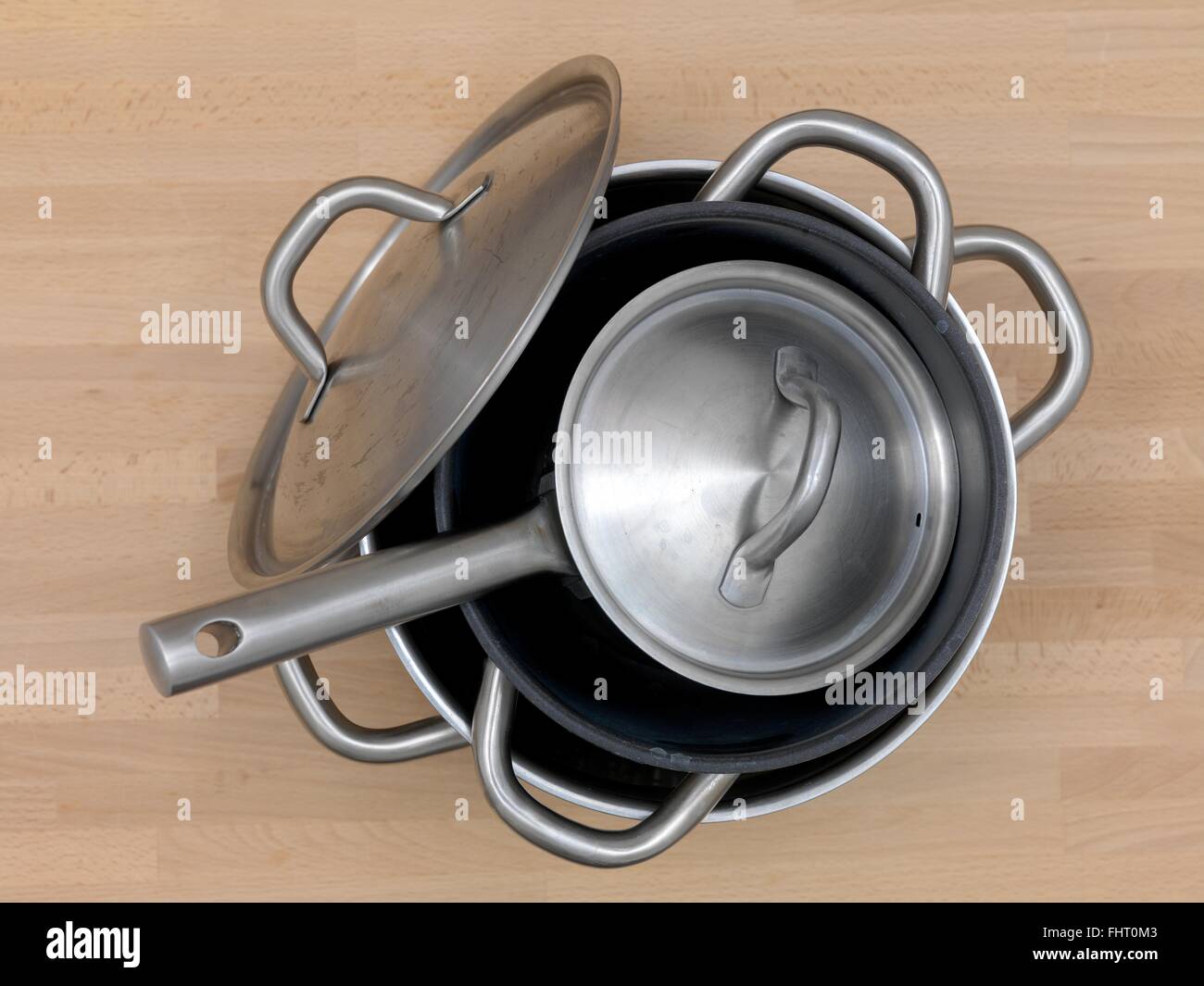 Pots and pans on a wooden kitchen bench Stock Photo - Alamy