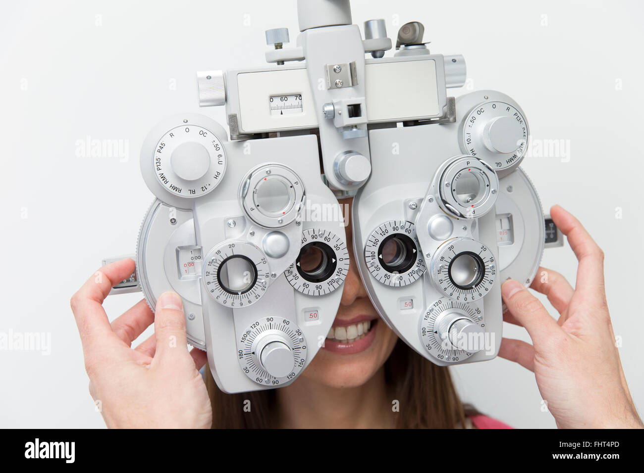 Woman at the optometrist making an eye test Stock Photo - Alamy