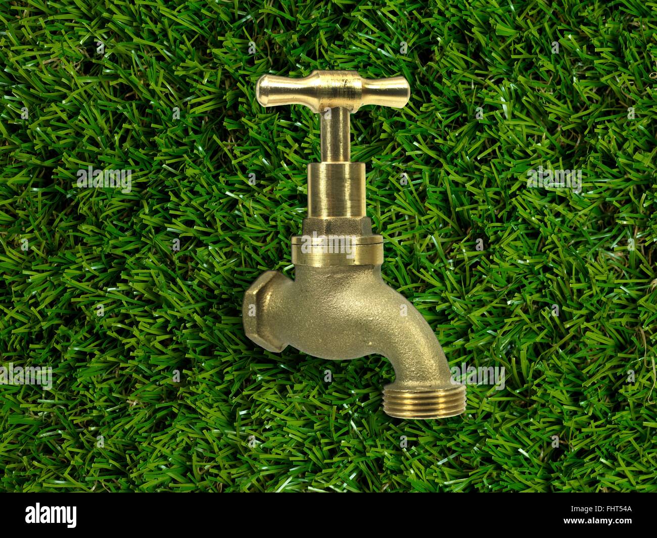 A tap isolated on artificle green grass Stock Photo - Alamy