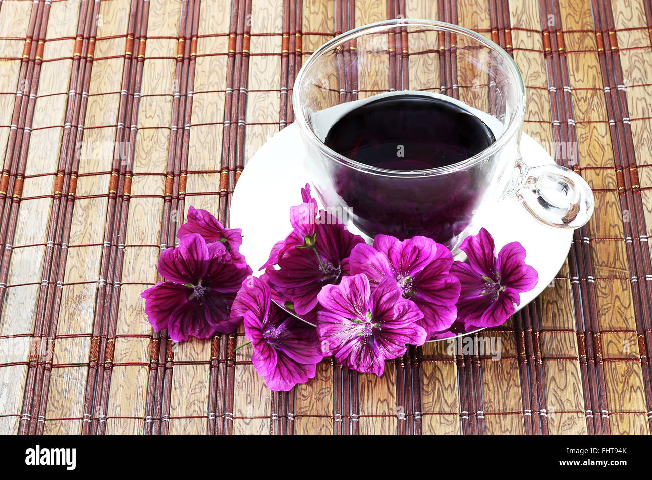 Cup with infusion of mauve flowers Stock Photo - Alamy