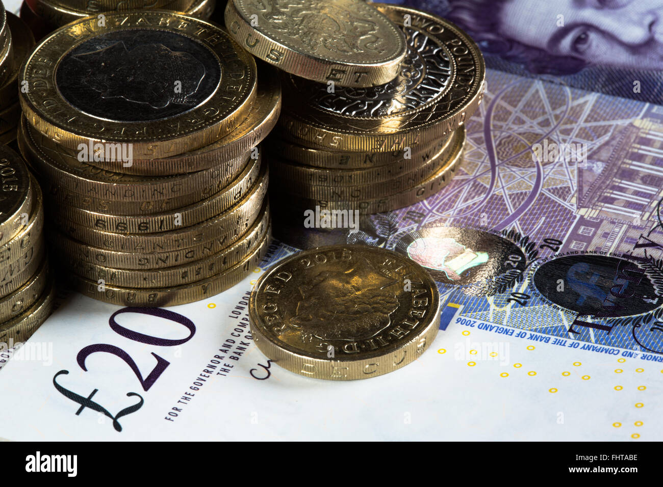 A macro image of coins and notes of the British Realm. Specifically Two ...