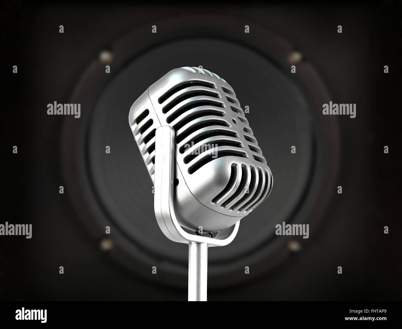 A microphone isolated against a speaker Stock Photo - Alamy