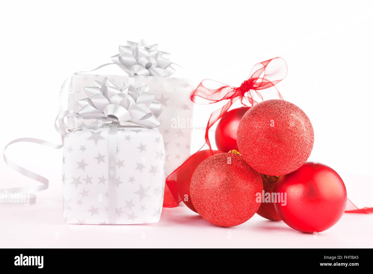 Luxury wrapped christmas present with balls and ribbon Stock Photo - Alamy