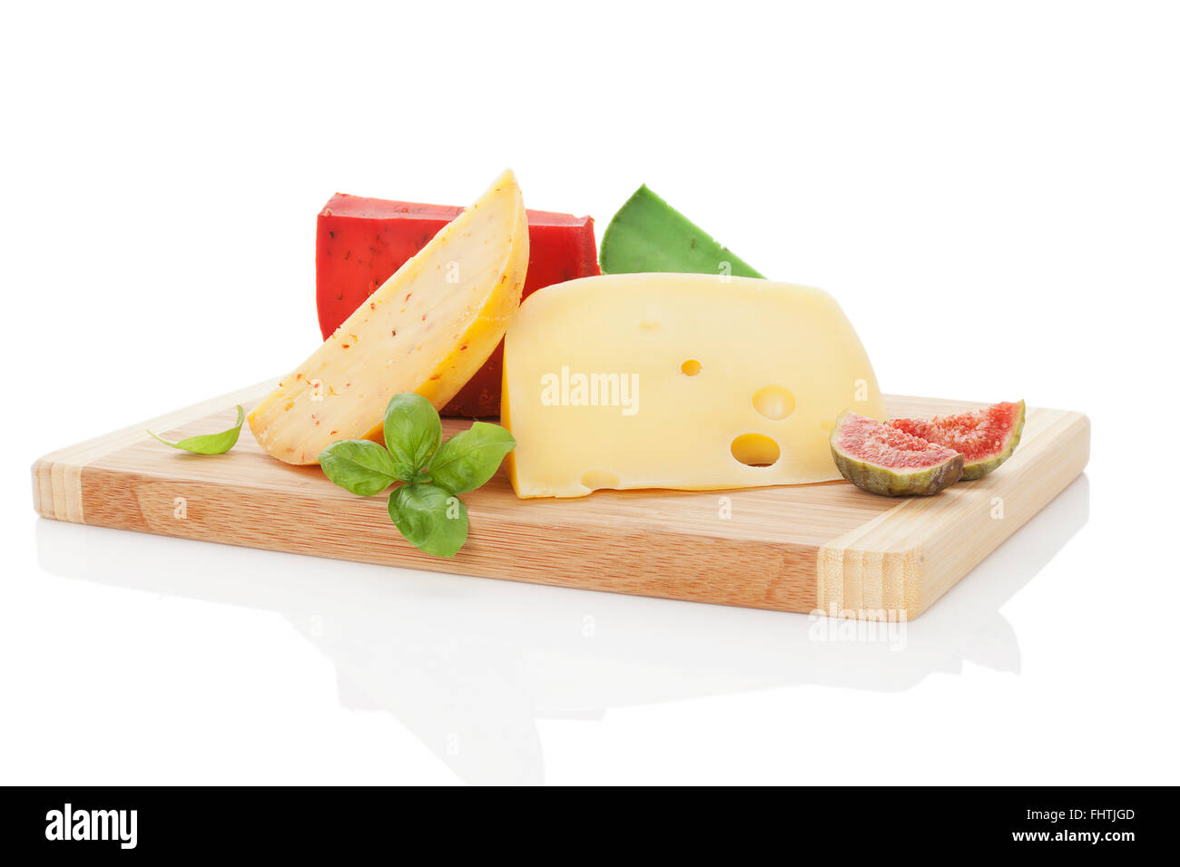 Colorful cheese assortment on chopping board Stock Photo - Alamy