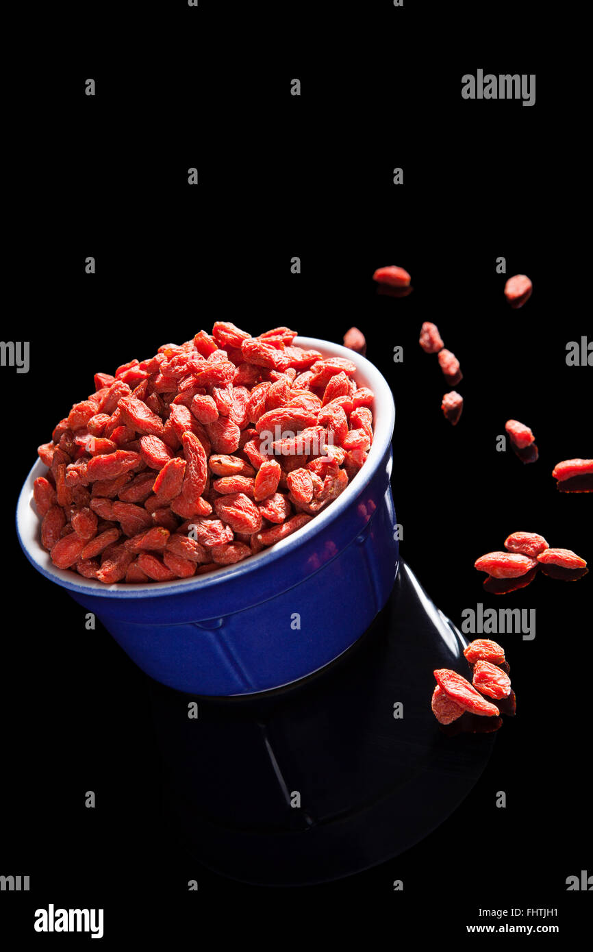 Wolfberries isolated on black Stock Photo - Alamy