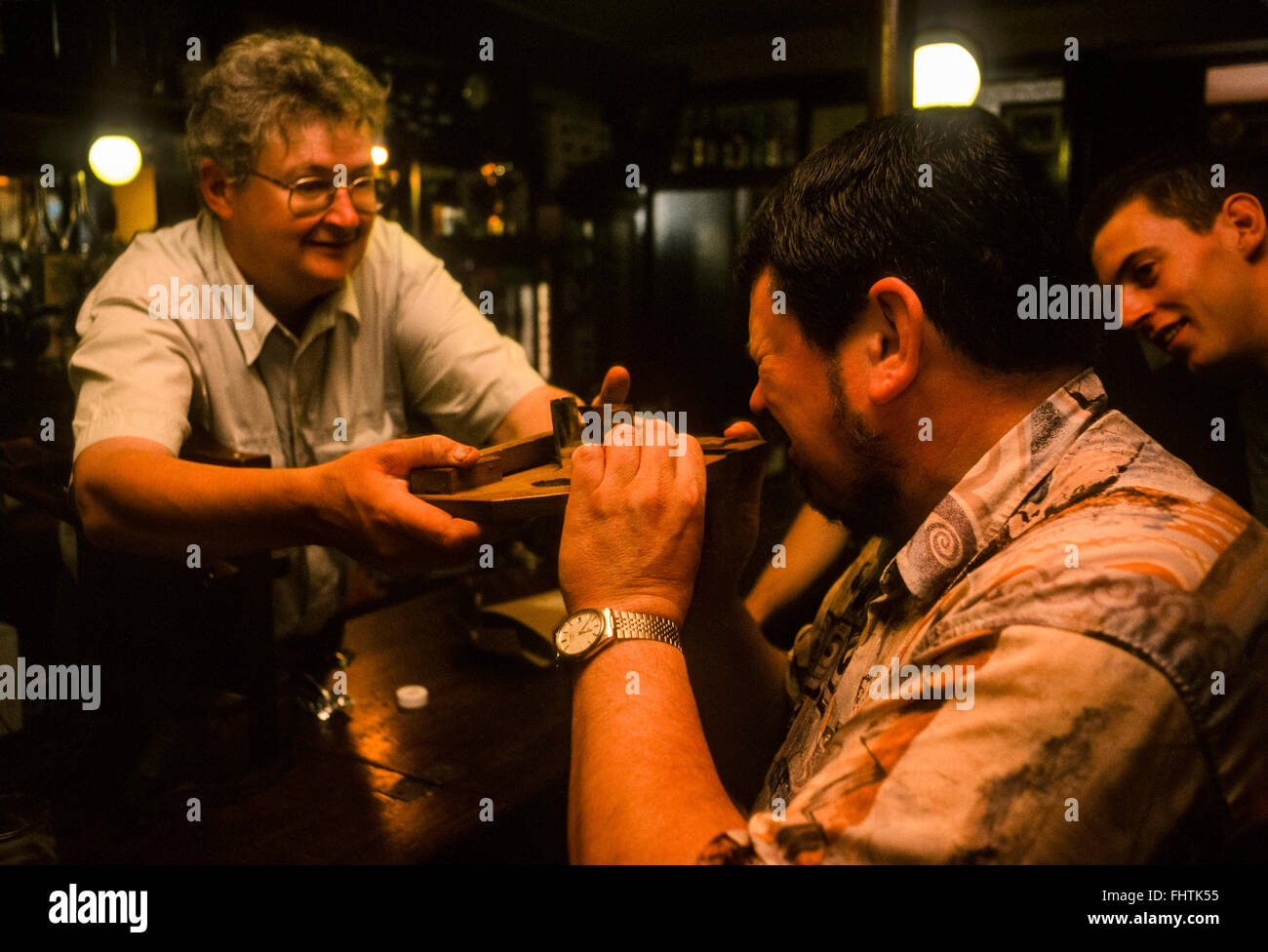 Edward Gaughan with a snuff inhaling machine helping a customer take a ...