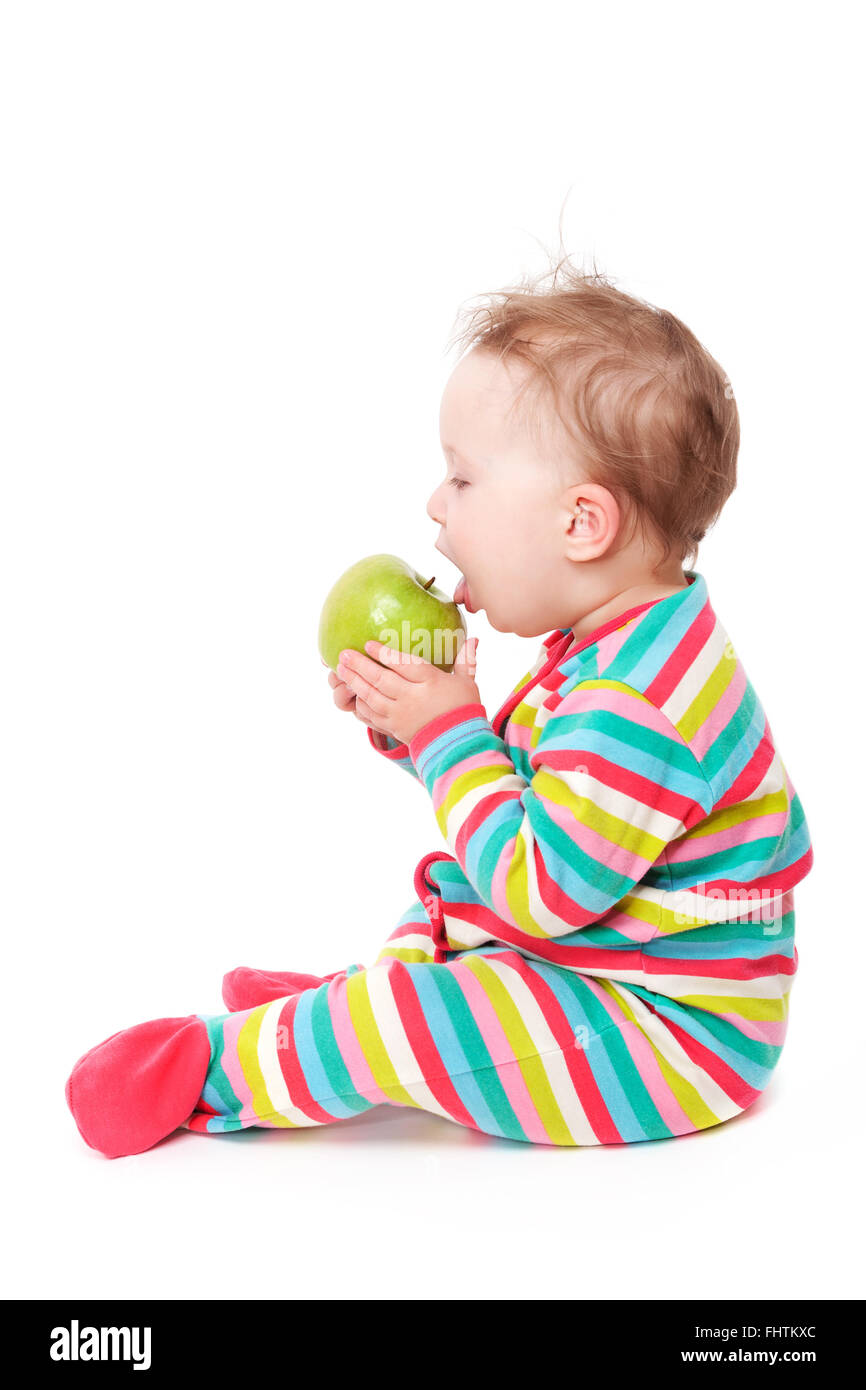 Baby girl eating apple isolated on white Stock Photo - Alamy