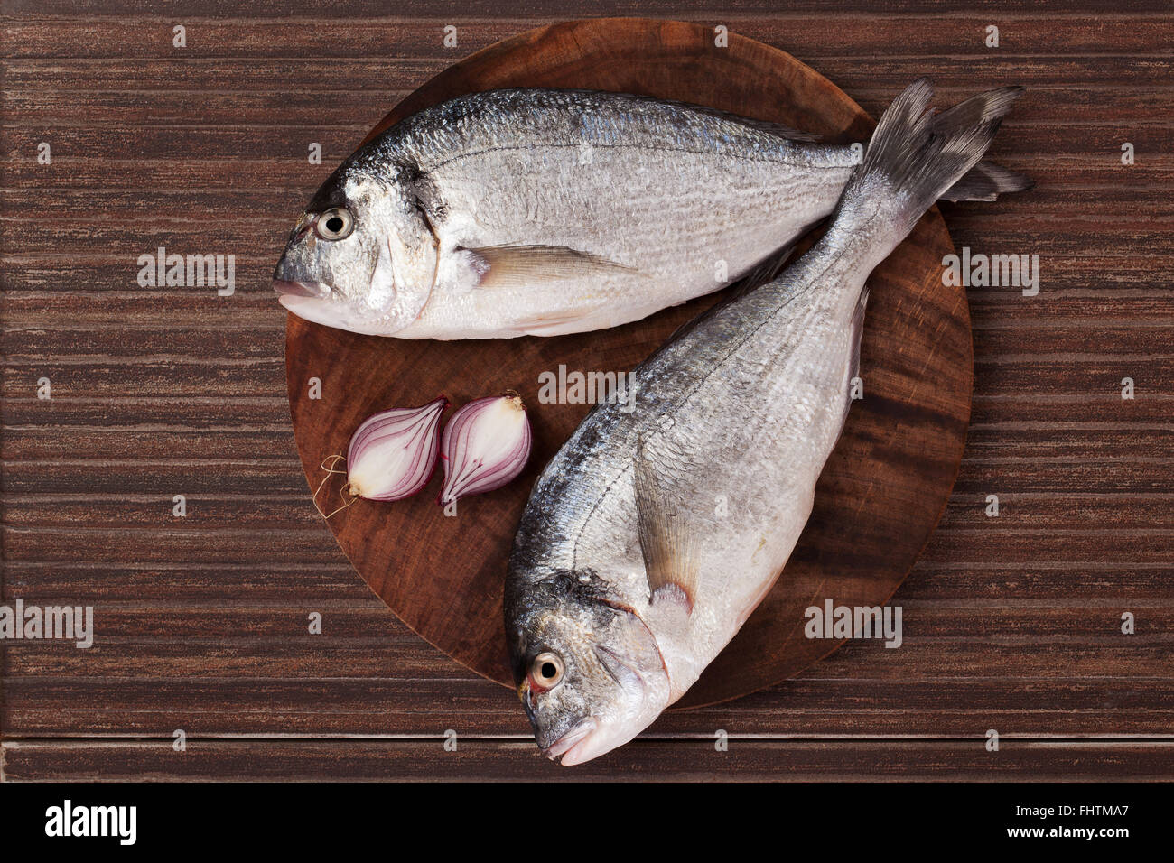 Fish on wooden chopping board Stock Photo - Alamy