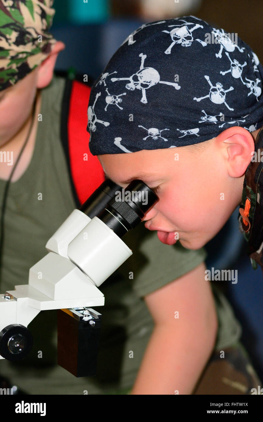 young boy looking down a microscope Stock Photo - Alamy
