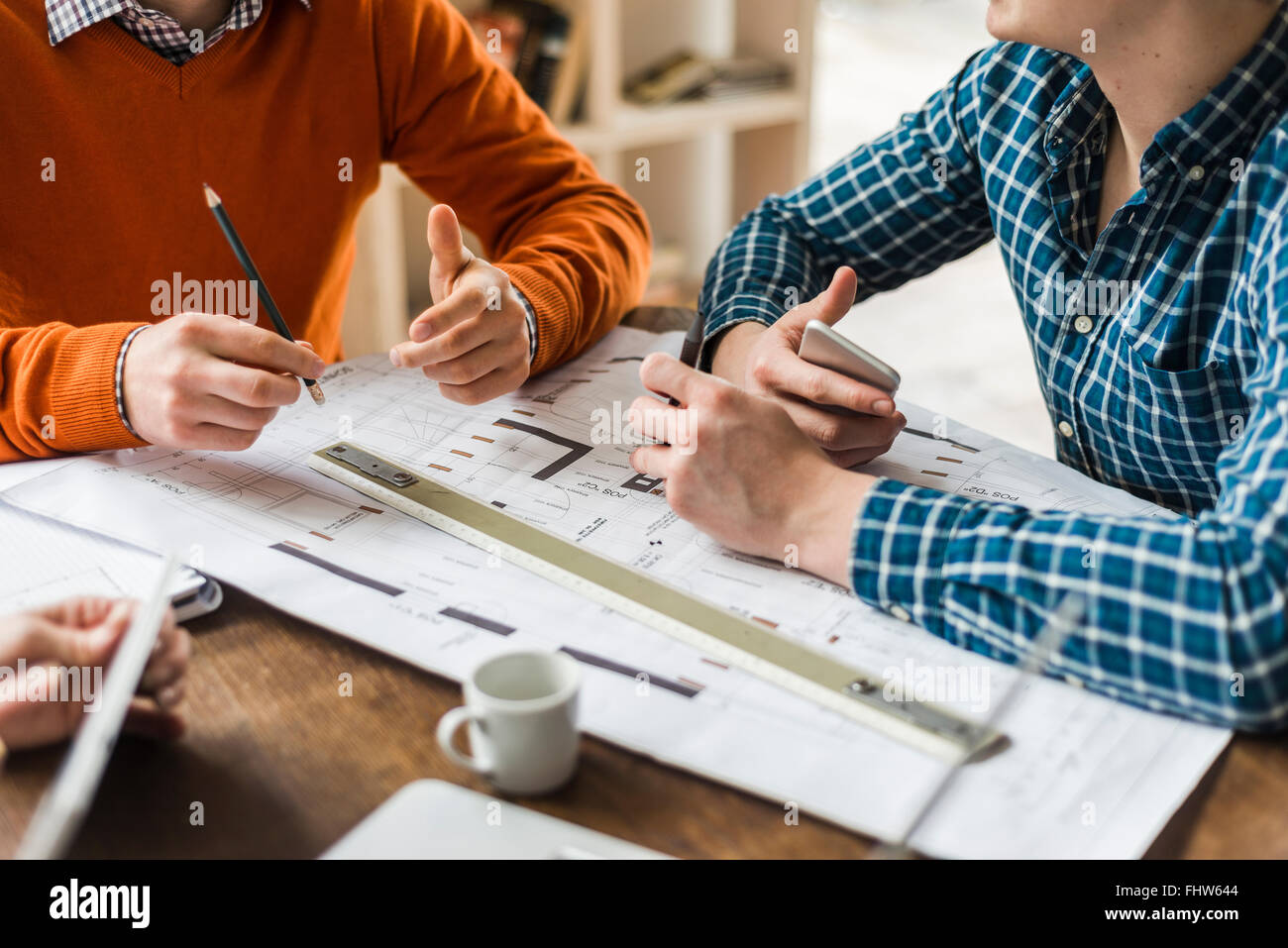 Colleagues discussing plan in office Stock Photo - Alamy