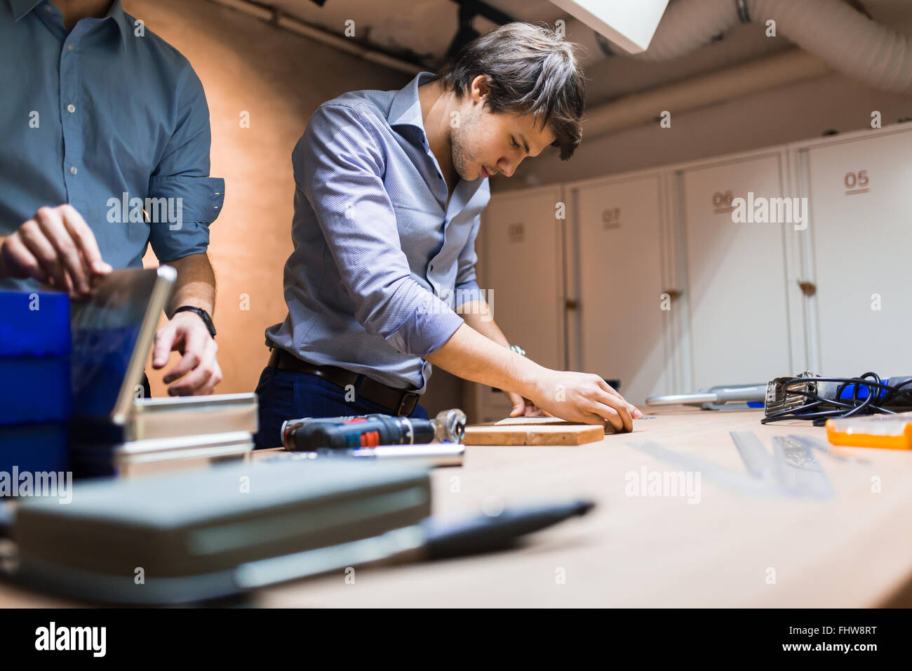 Handyman working with wood with precision tools at hand Stock Photo - Alamy