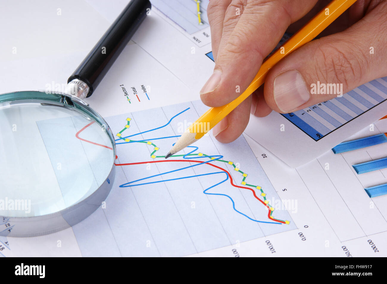 pencil in hand and working paper Stock Photo - Alamy