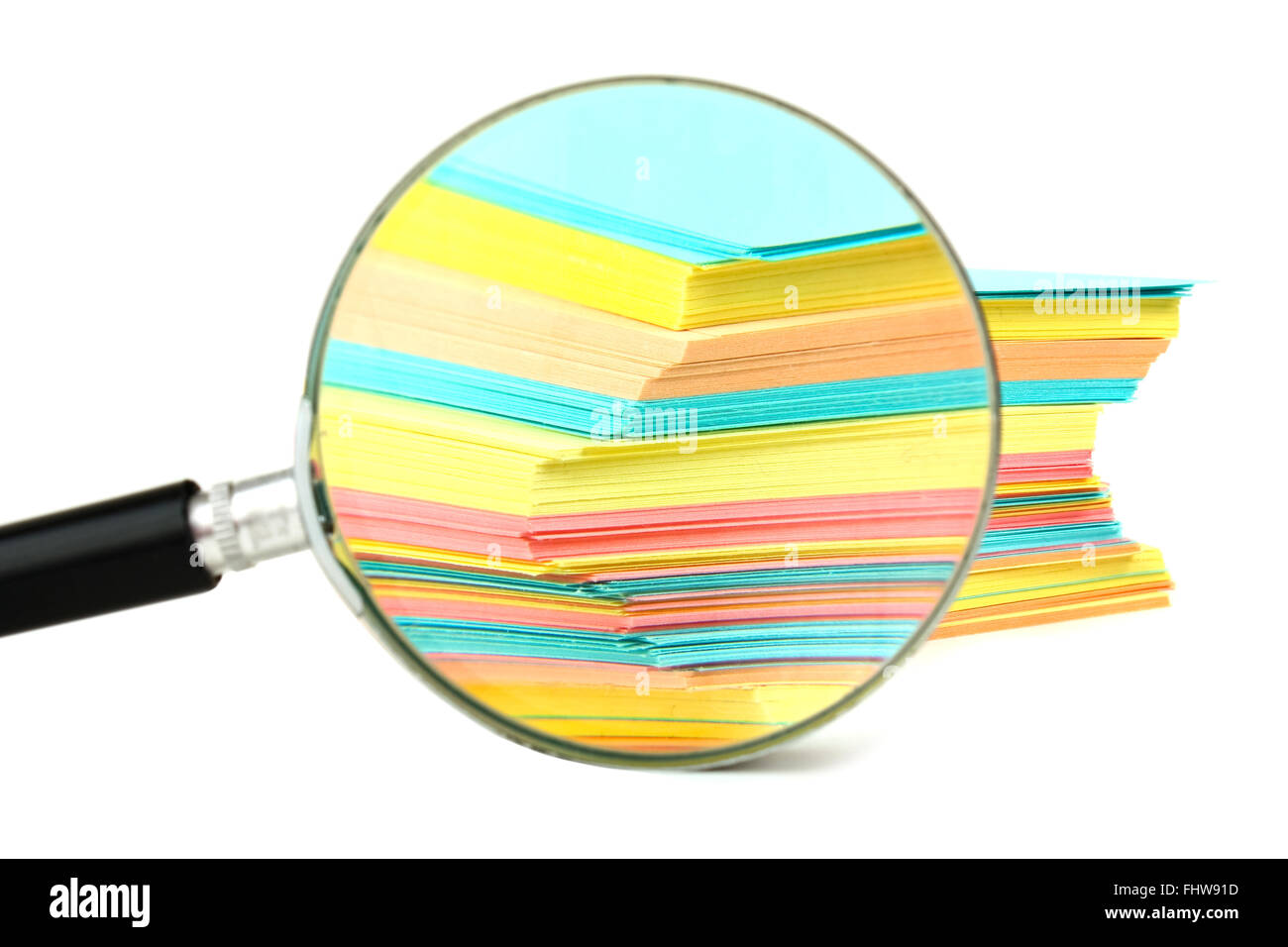 magnifying glass and a stack of paper Stock Photo - Alamy