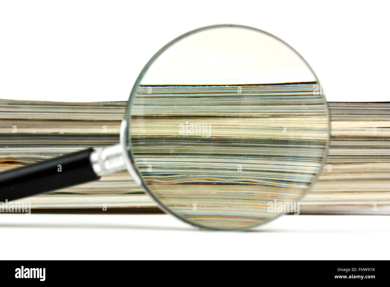 magnifying glass and magazines Stock Photo - Alamy