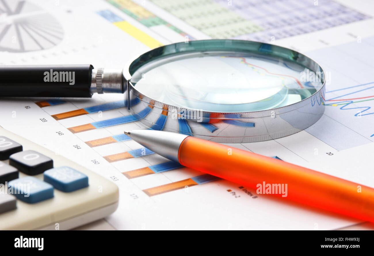 magnifying glass and the working paper Stock Photo - Alamy