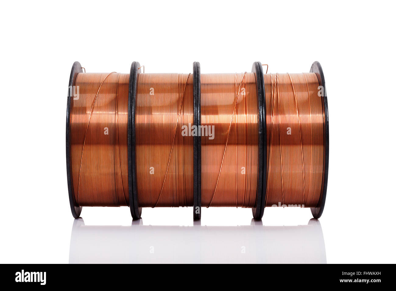 Copper welding wire wounded on the spools isolated on white. Wire rolls ...