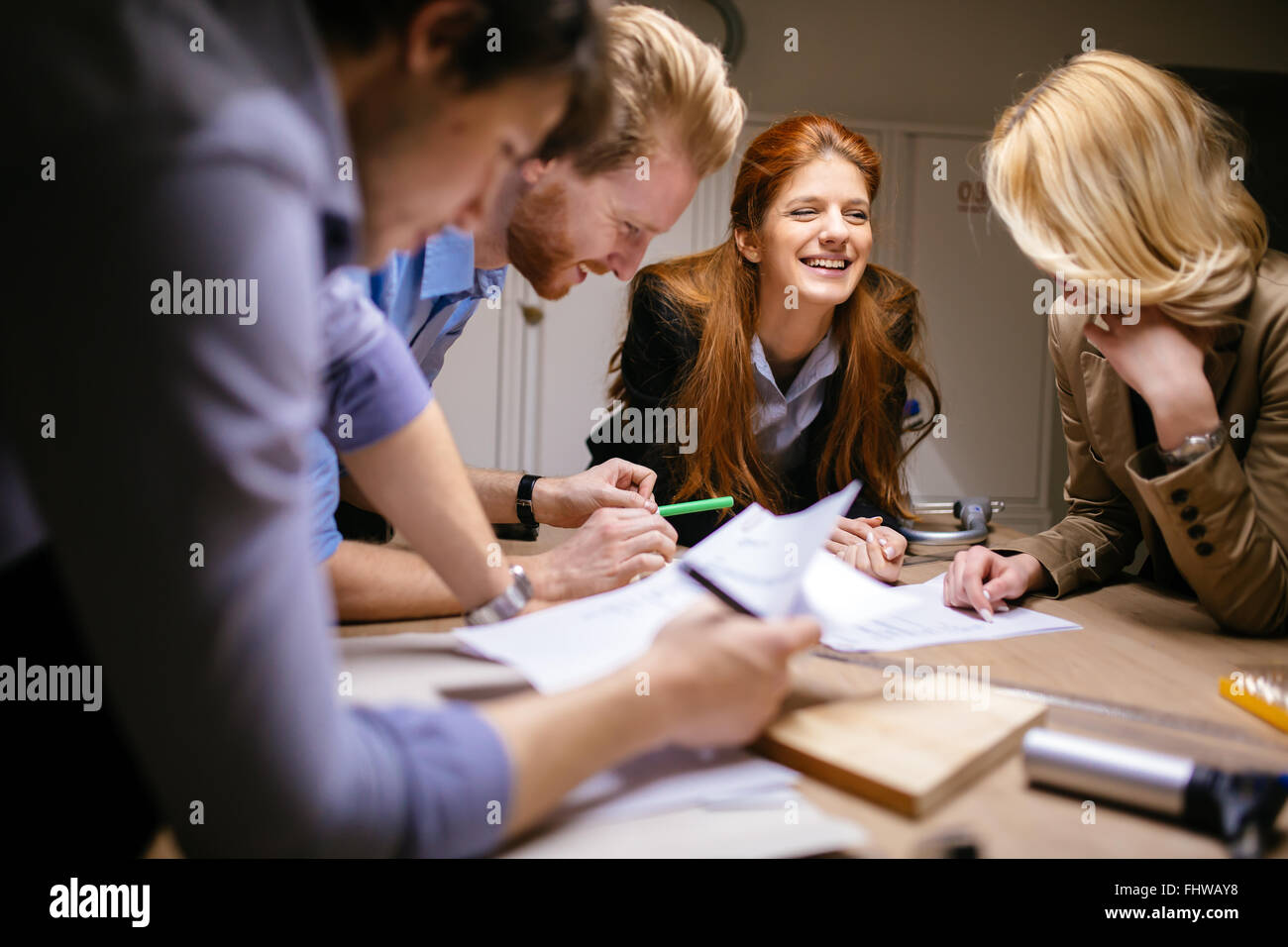Classmates working on a project together and cooperating Stock Photo ...