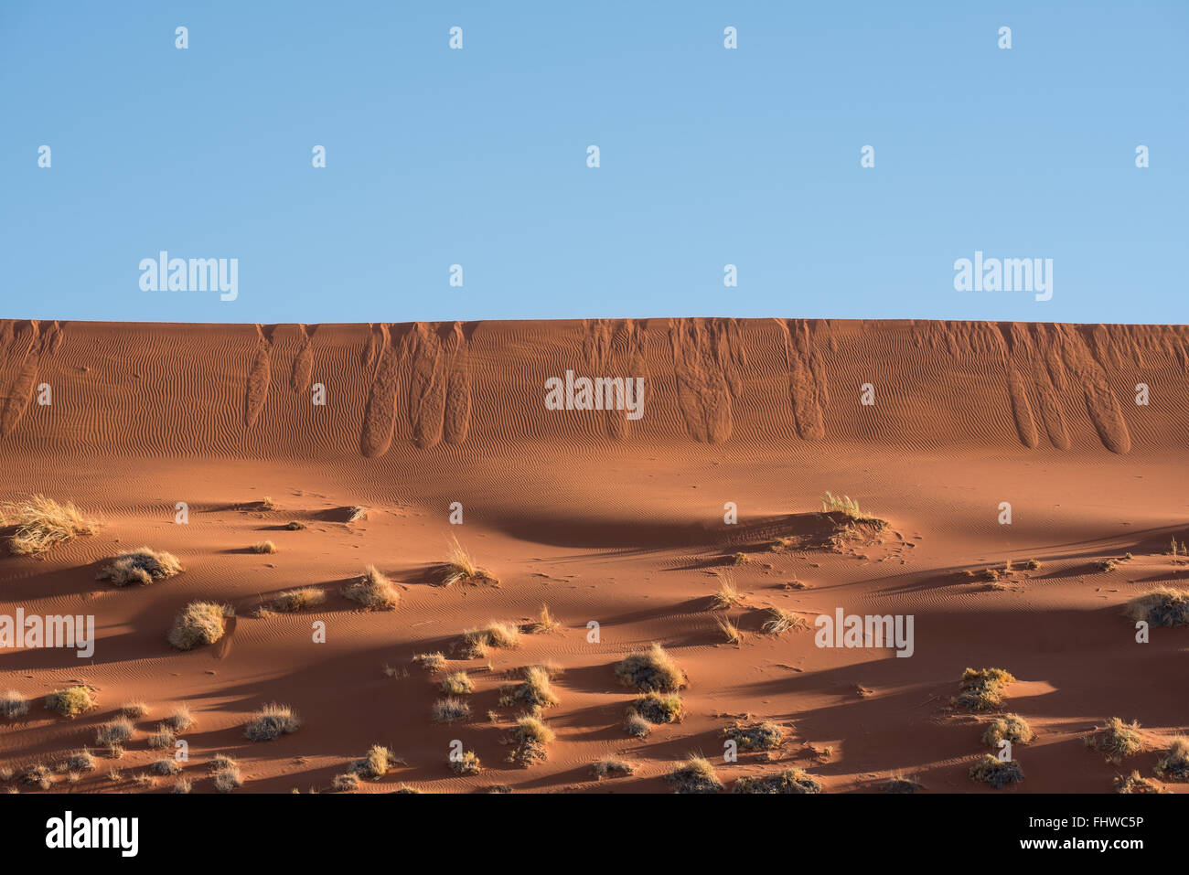 Sand spilling over the top of a sand dune in the Namib Desert Stock ...