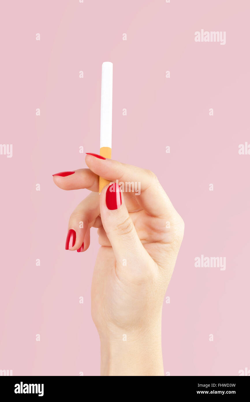 Female hand holding cigarette Stock Photo - Alamy