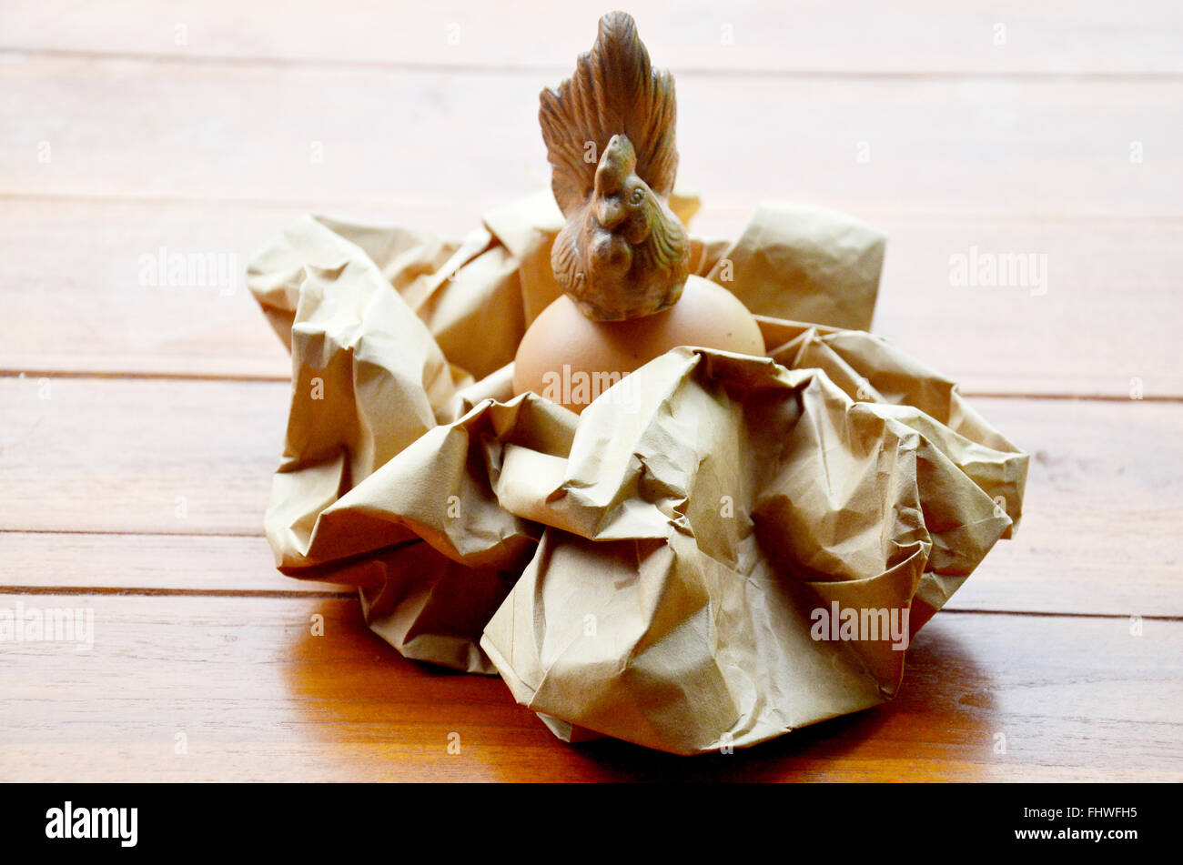 Chicken doll on egg at paper nest Stock Photo - Alamy