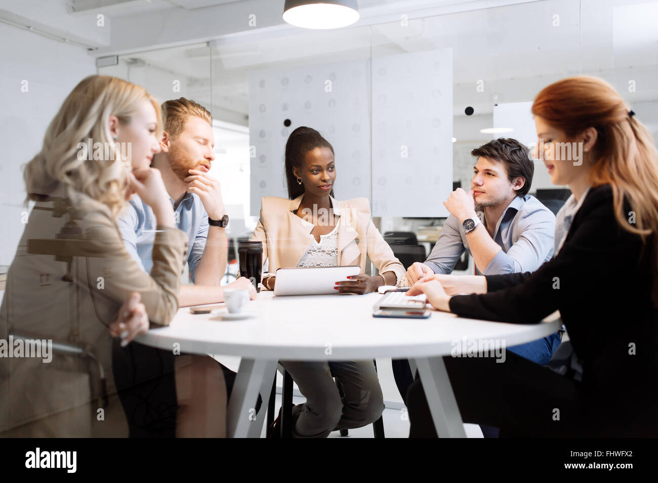 Group of business people sitting at desk and discussing new ideas Stock ...