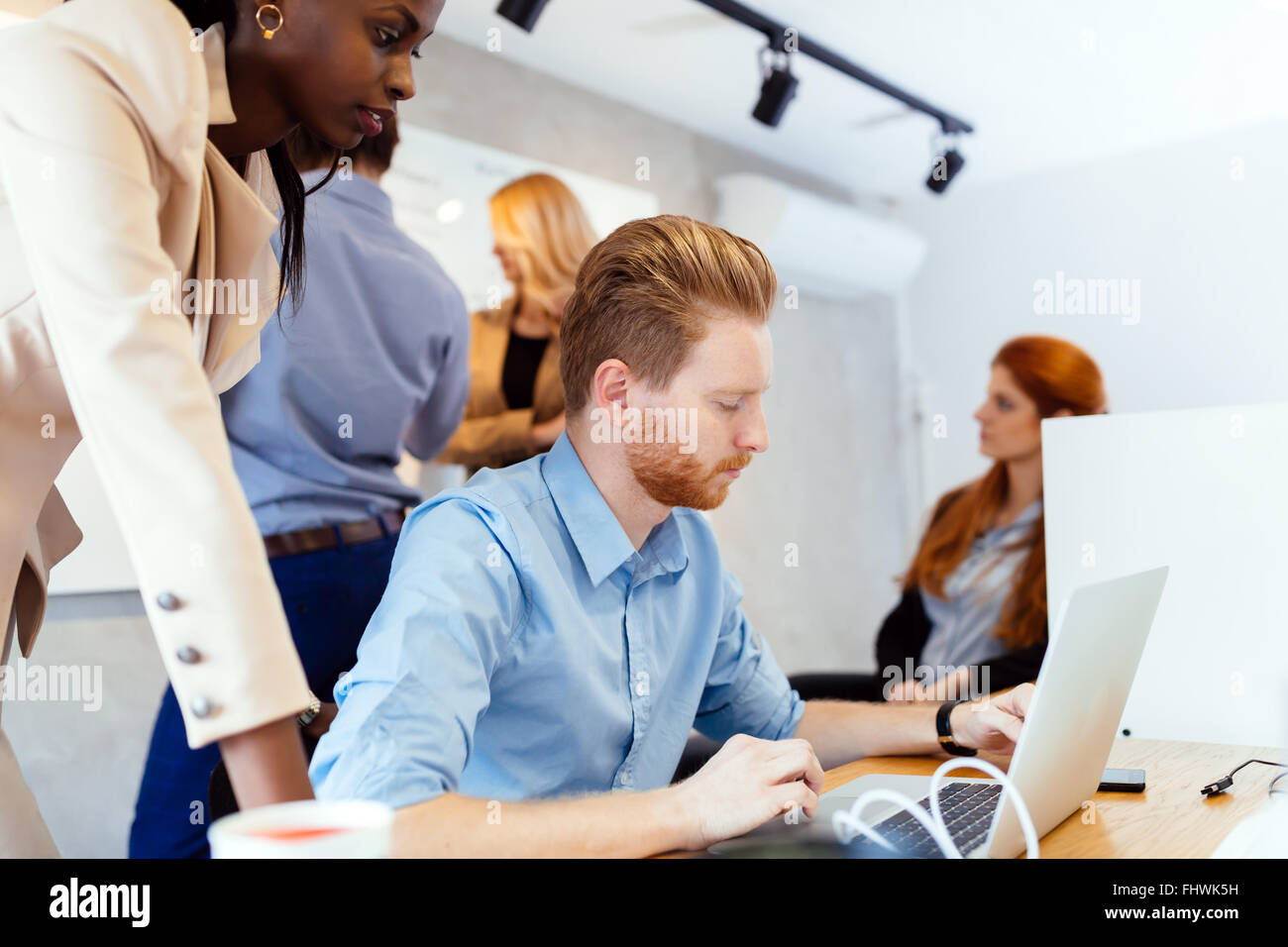 Business people collaborate in office and work on computer Stock Photo ...