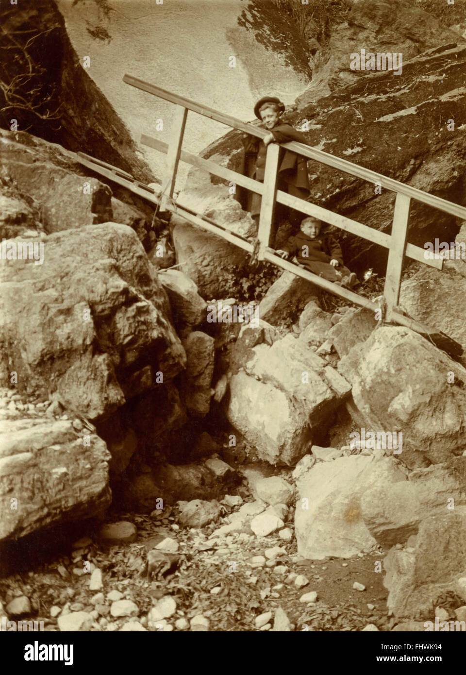 Two kids on a ladder between the rocks Stock Photo - Alamy