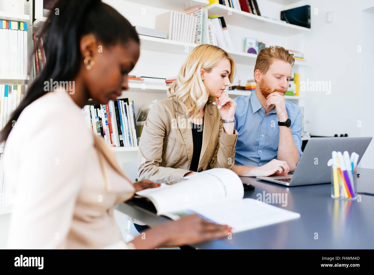 Multiethnic people working in modern well equipped office Stock Photo ...