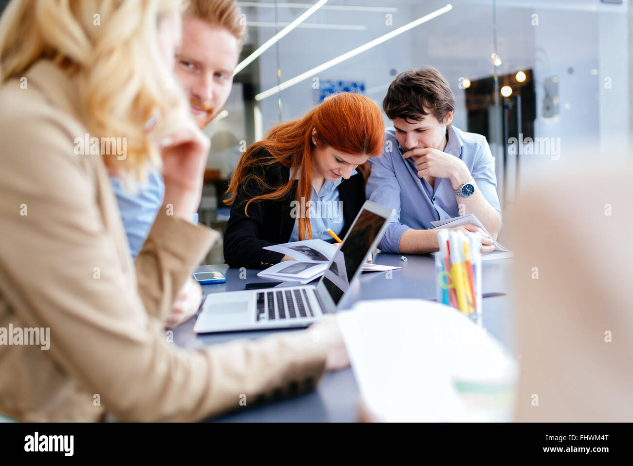 Business people collaborating in office and working on project together ...