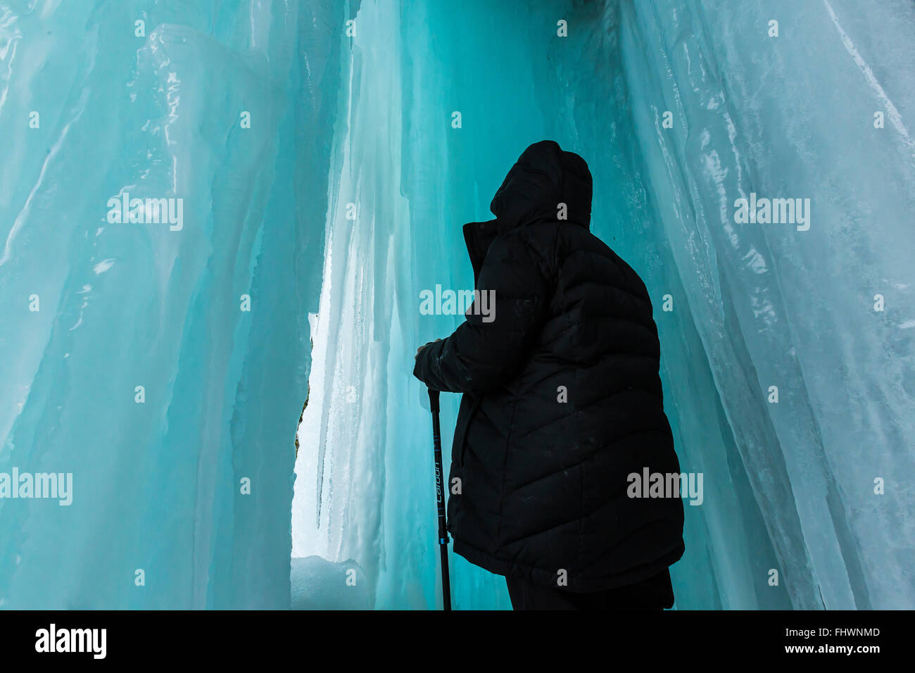Hiker with translucent ice in The Curtains ice formation, Pictured ...
