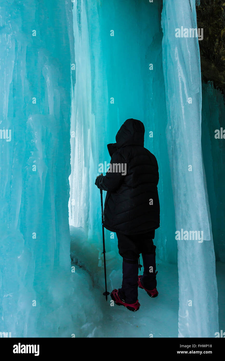 Hiker with translucent ice in The Curtains ice formation, Pictured ...