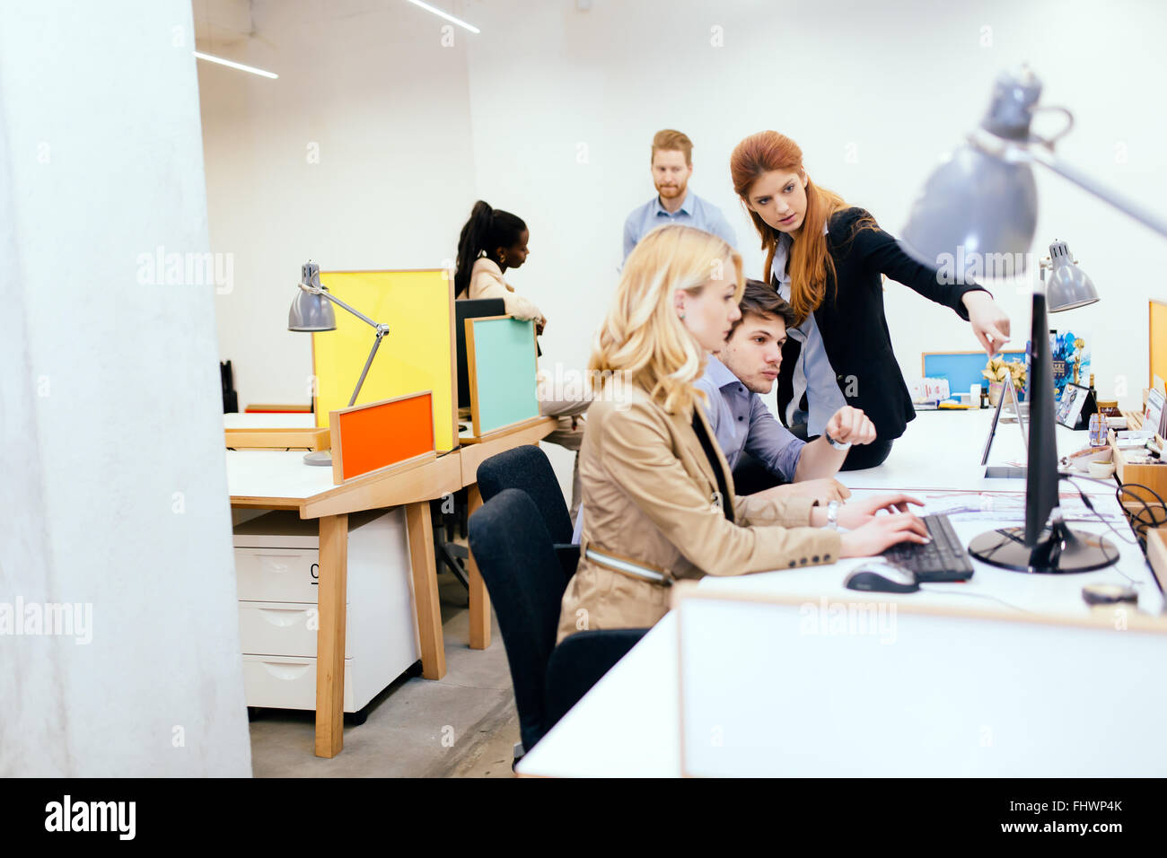 Coworkers solving problems together in modern office Stock Photo - Alamy