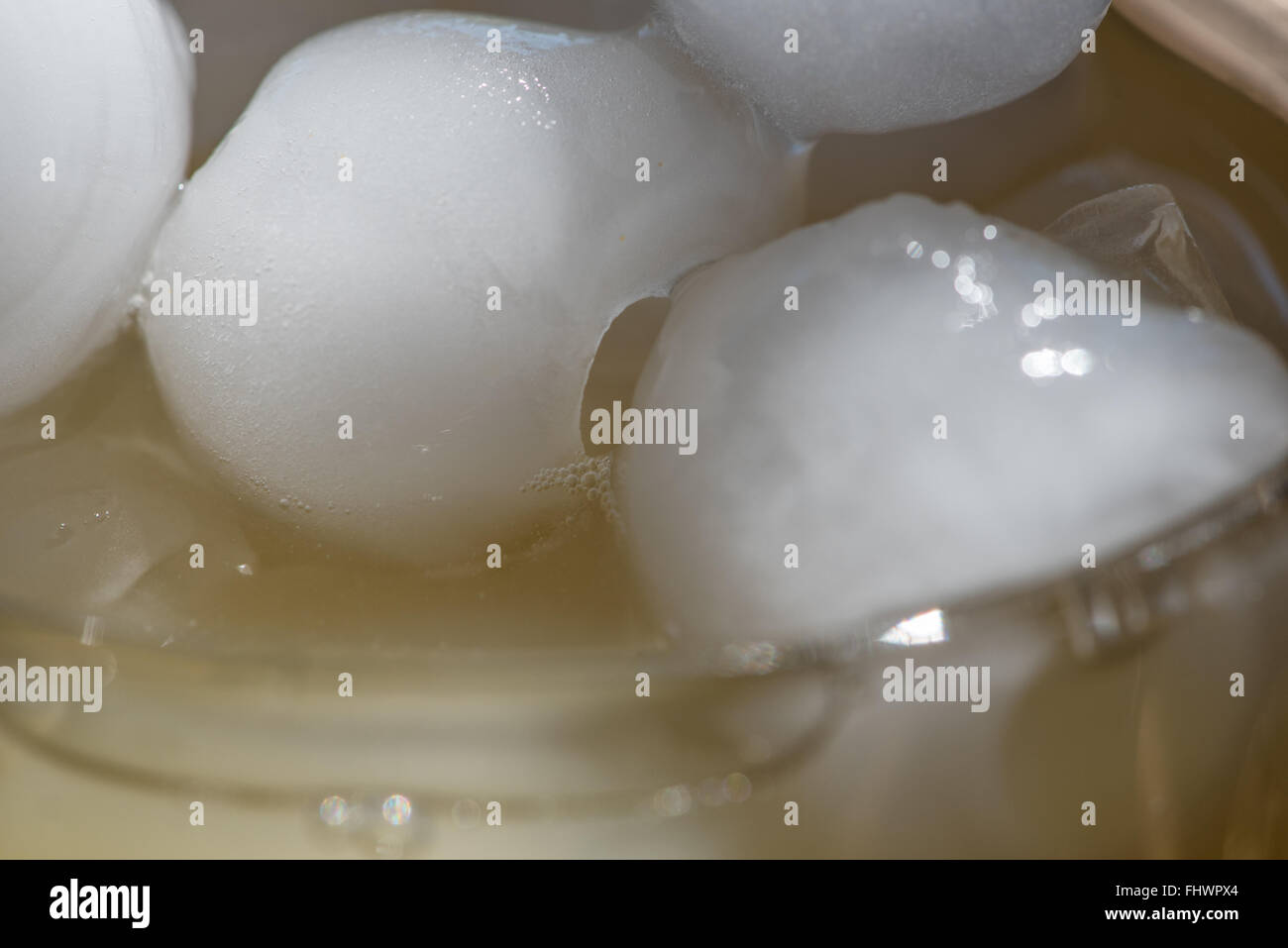 Blocks of ice in a glass of fruit juice Stock Photo - Alamy