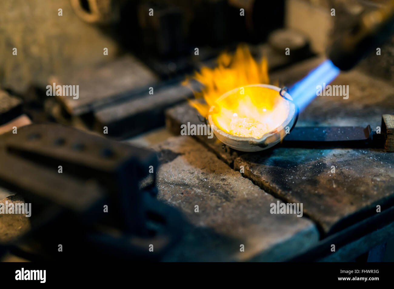 Jeweler welding gold the traditional way Stock Photo - Alamy