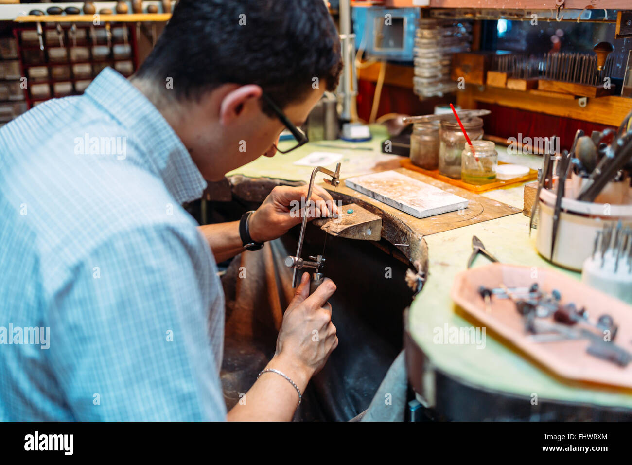 Worker working with his tools on a workbench Stock Photo - Alamy