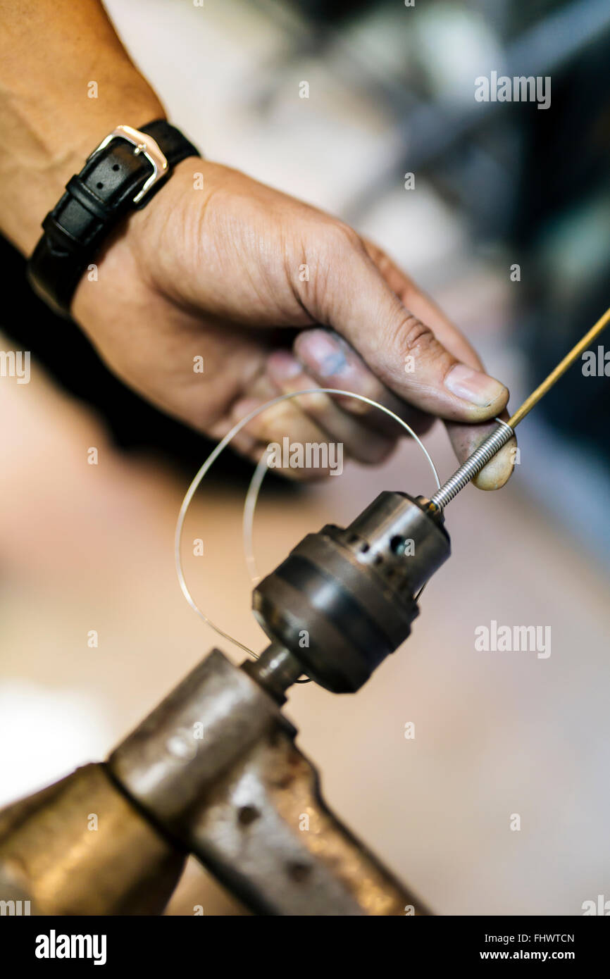 DIY, metal string wrapped around drill Stock Photo - Alamy
